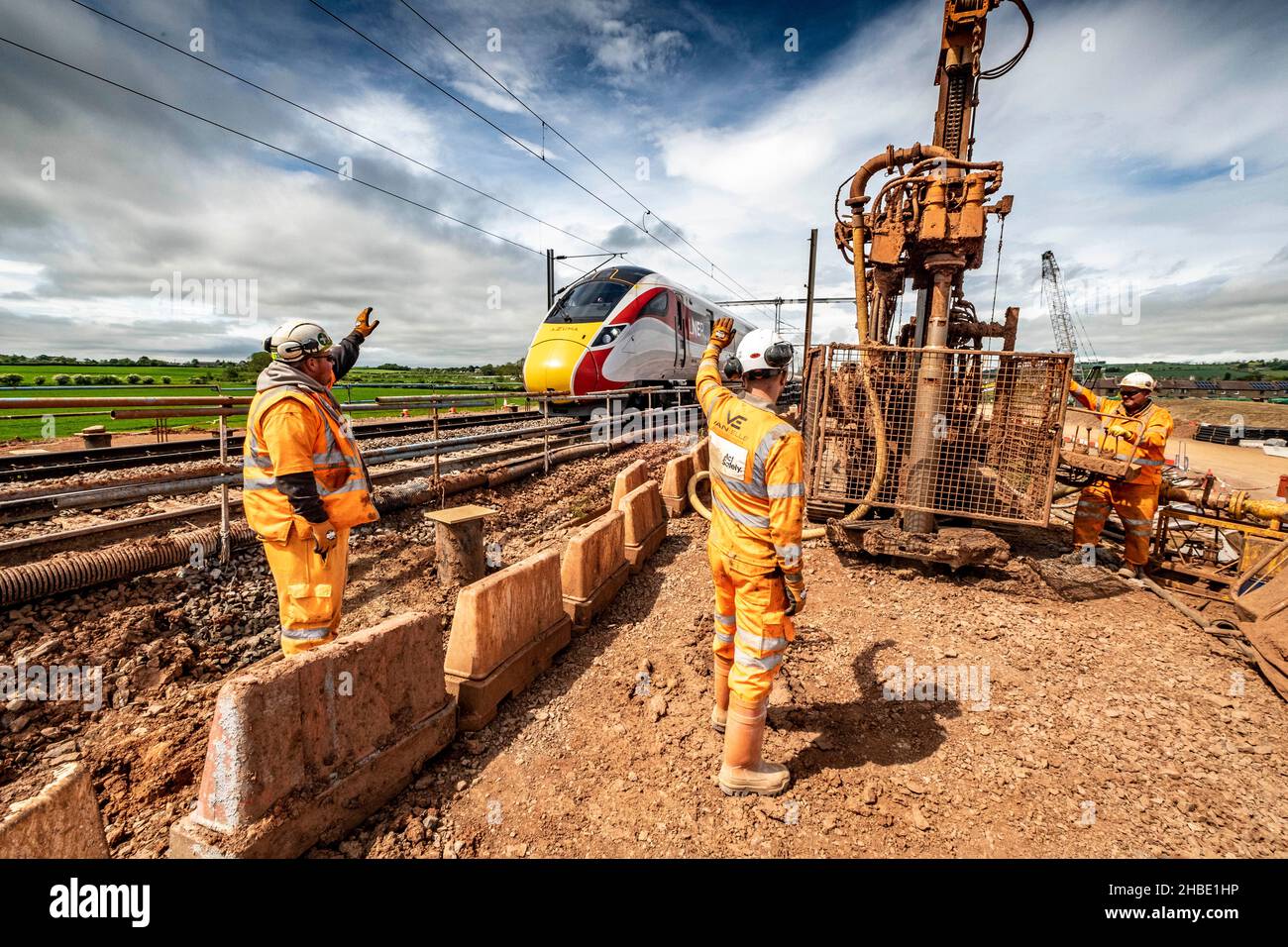 Railway workers building new railway and knocking down bridges Stock ...