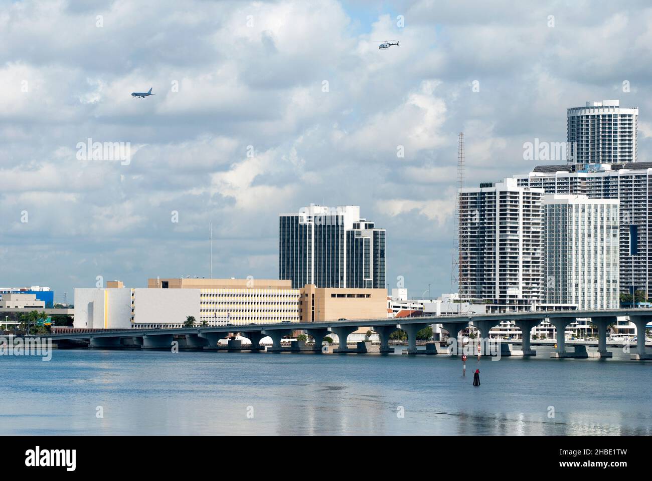 An airplane and a helicopter flying over Miami downtown (Florida Stock ...