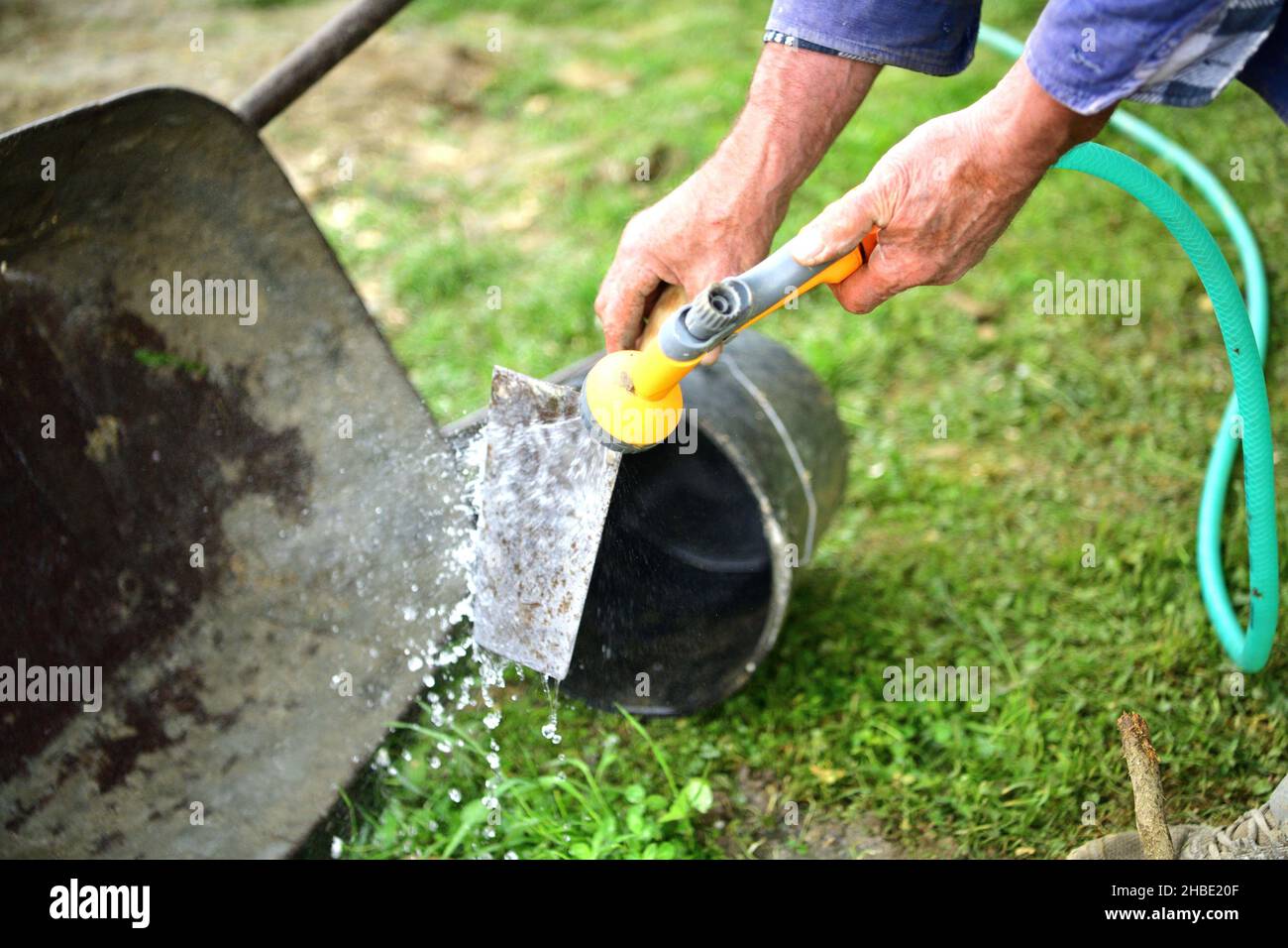 After finishing the work, the mason cleans pail tools with water Stock ...