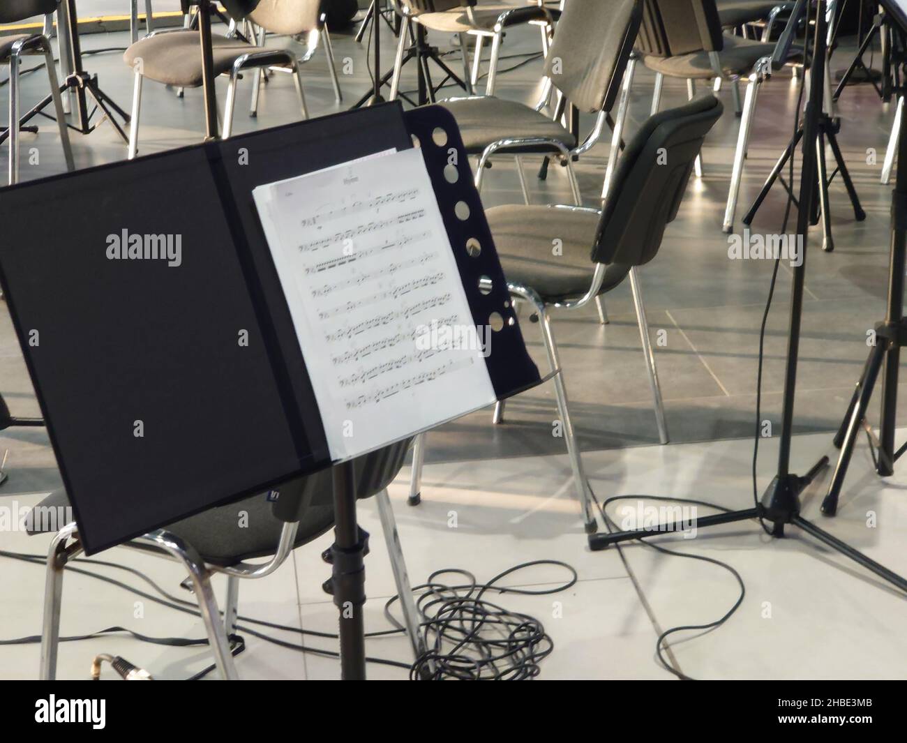 Musical score displayed on a stand on stage at a concert viewed in ...