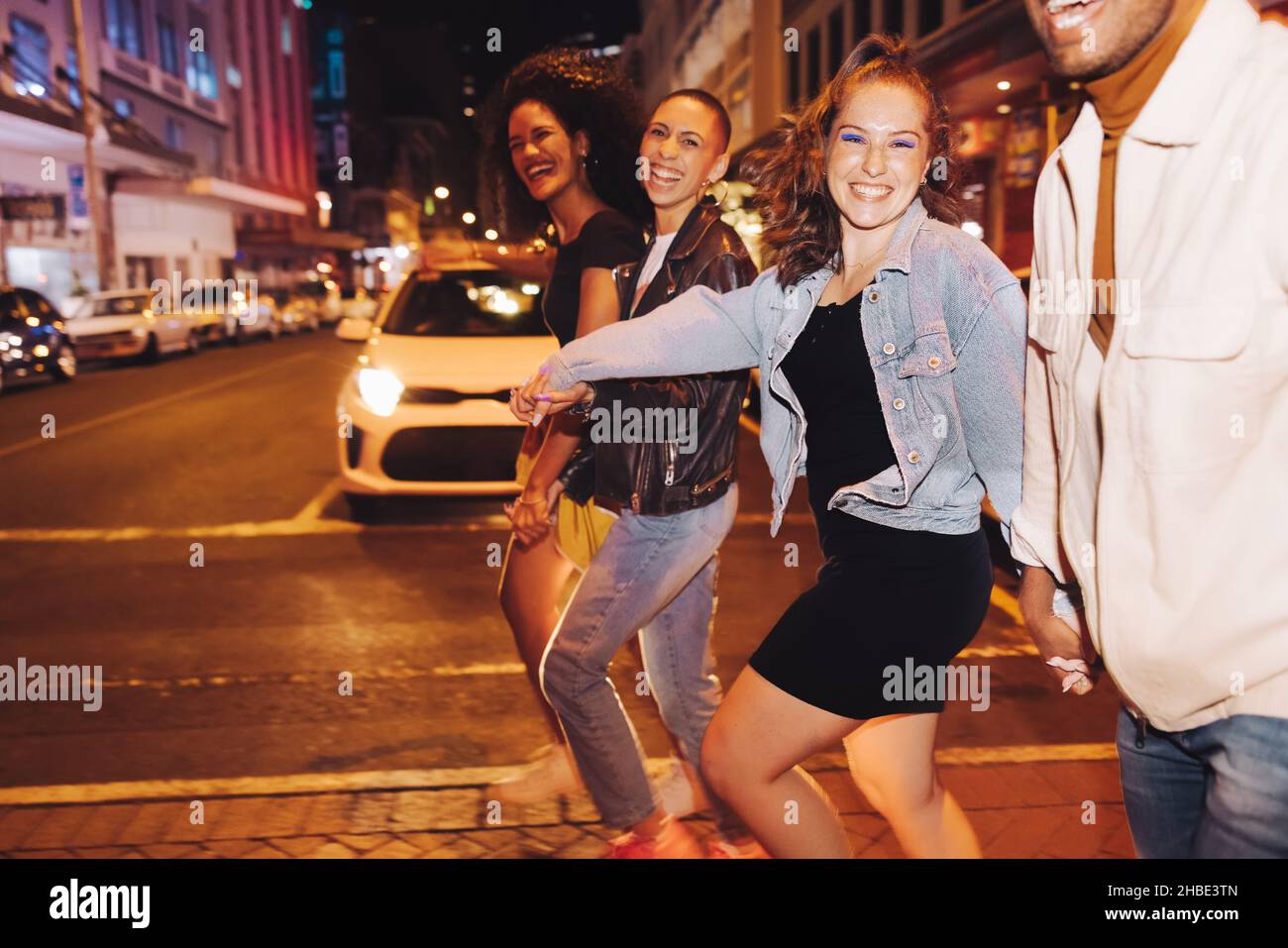 Generation Z friends going out together at night. Happy friends smiling ...