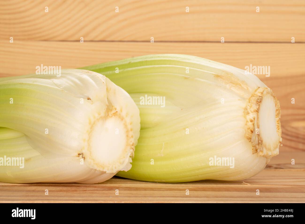 Two light green natural, juicy stalks of celery, close-up, against a ...