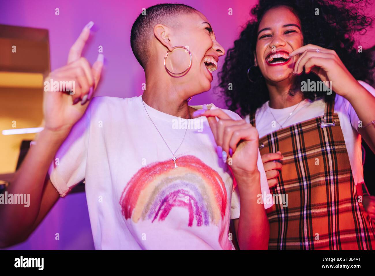 Best friends dancing to their favourite song at a party. Two happy ...