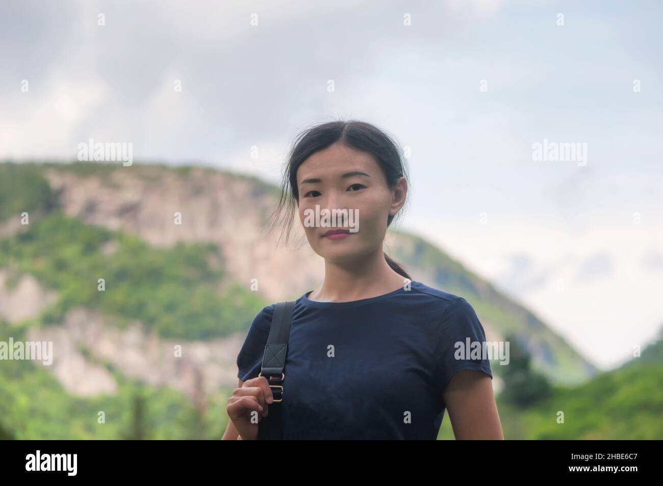 A chinese woman standing in crawford notch with a blurred background of ...
