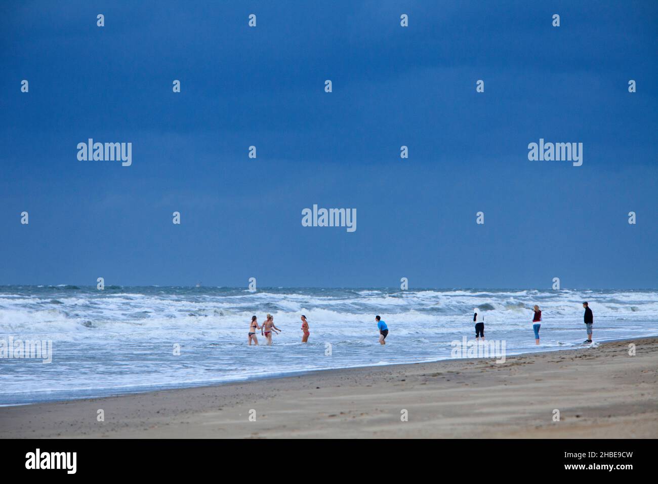 People on beach, bathing in the North Sea, island of Texel, Holland ...