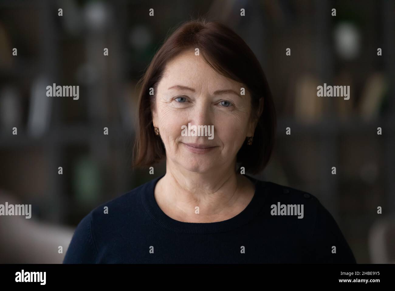 Profile picture of calm elderly female pensioner looking at camera ...