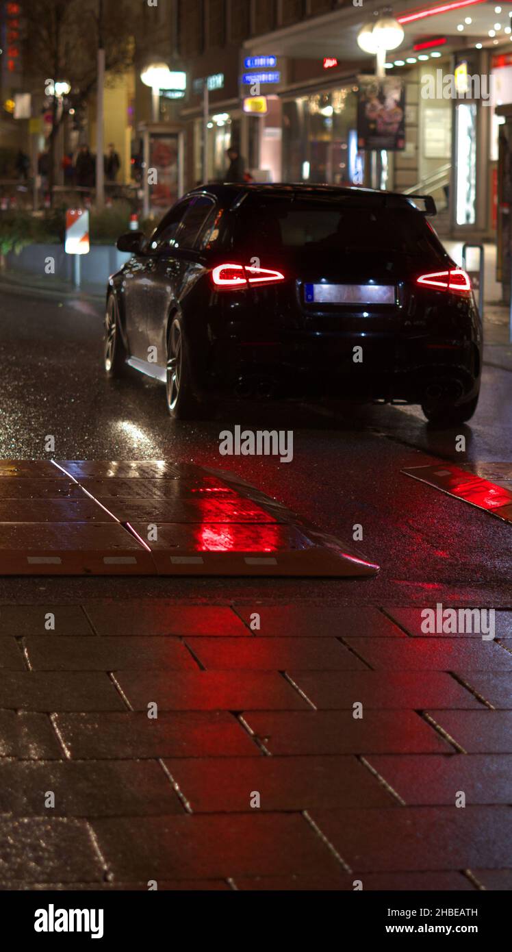 New car on a wet street Stock Photo - Alamy
