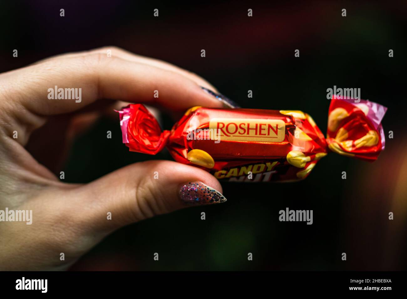 BUCHAREST, ROMANIA - Nov 29, 2021: A hand holding ROSHEN chocolate ...
