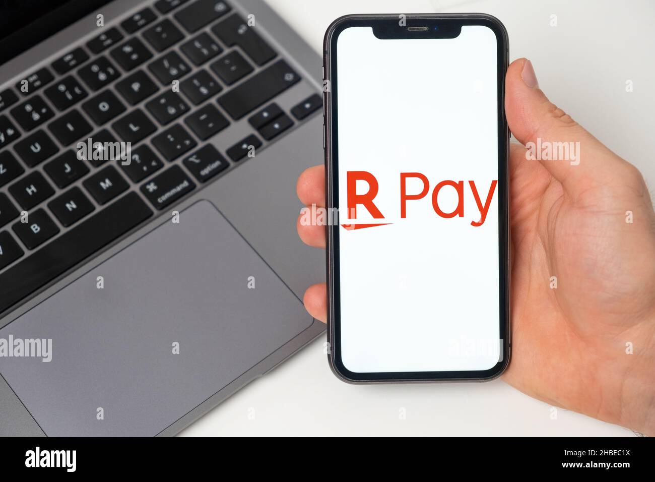 R Pay crypto wallet logo on the screen of mobile phone and notebook on ...