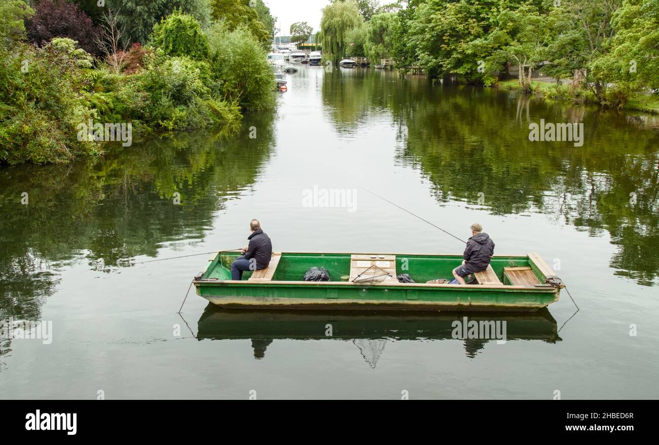 Two Men Fishing On A Chain Moored Punt Boat In The Bridge Pool On The ...