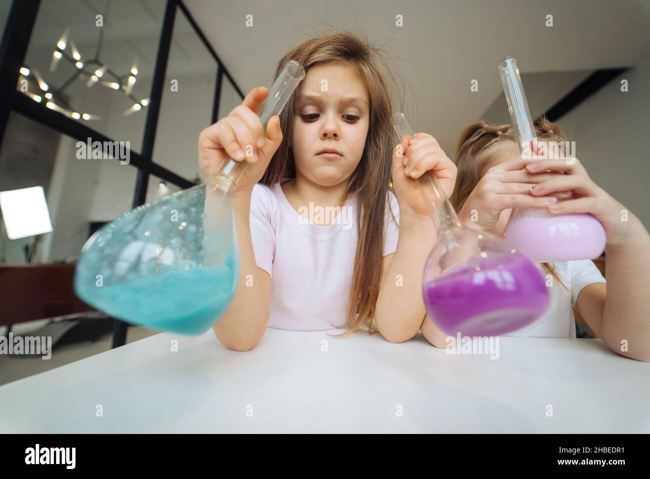 Little girls making chemical experiments at home Stock Photo - Alamy