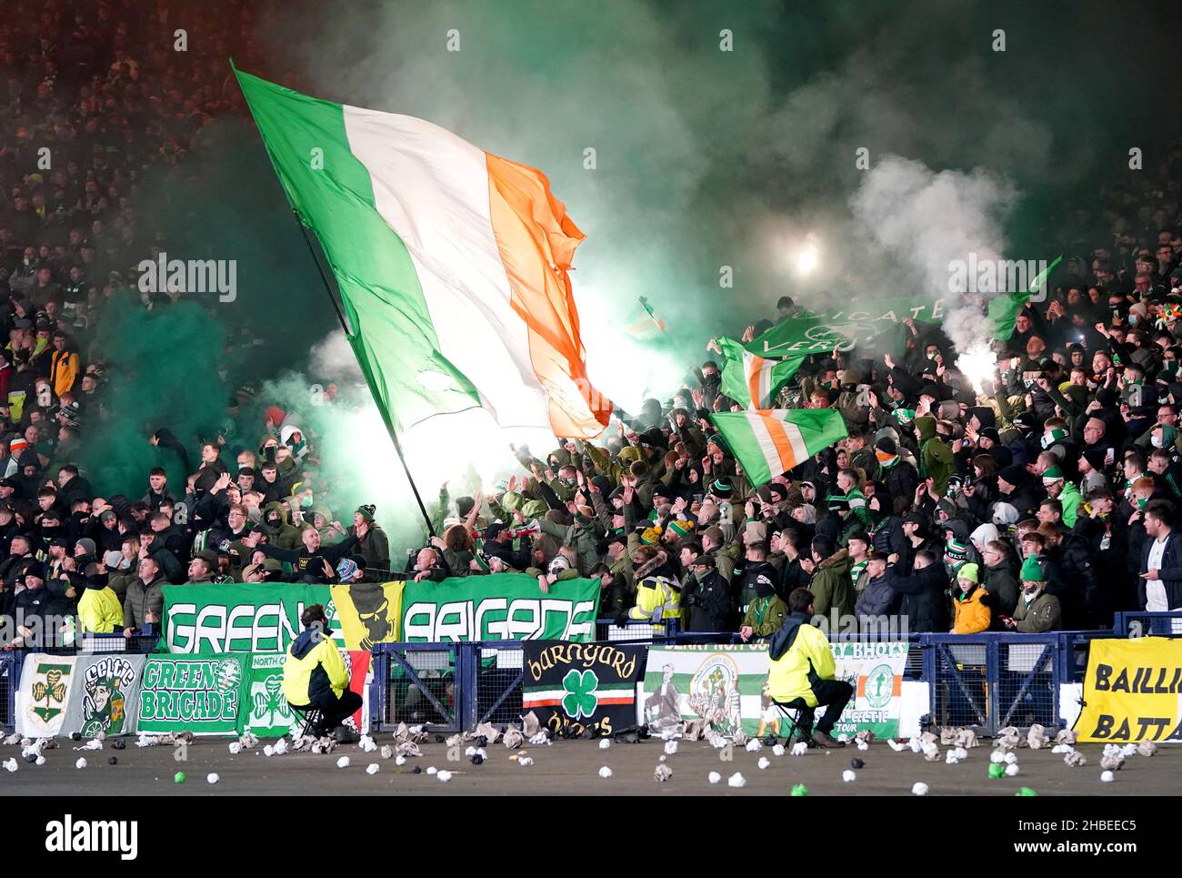 Celtic fans wave flags and light flares in the stands during the ...