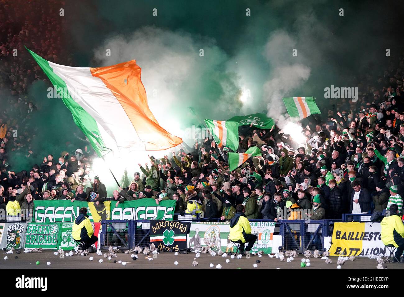 Celtic fans wave flags and light flares in the stands during the ...