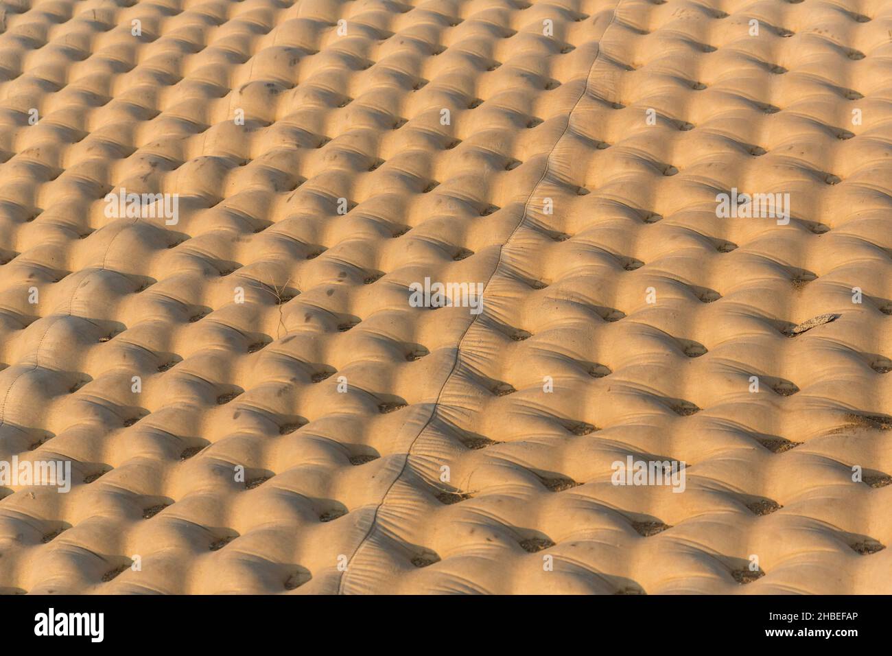 Bumpy concrete channel lining texture under beautiful golden light ...