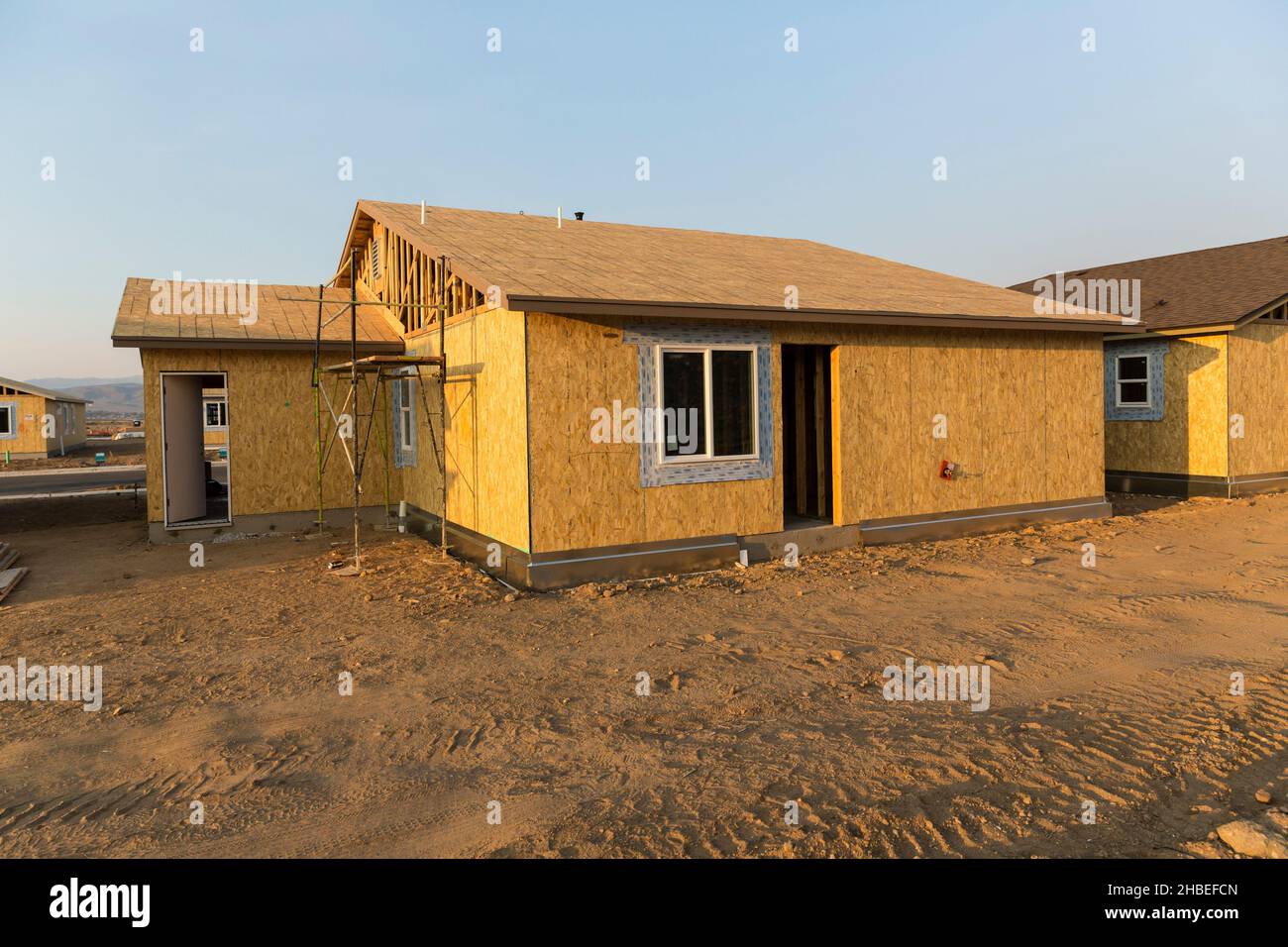 Unfinished housing on the dirt lot back view with doors open Stock ...