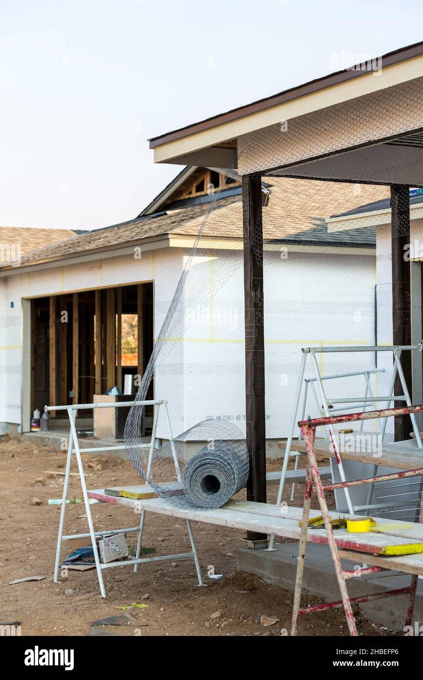 Scaffolding holding net wire and construction workers tools outside new ...