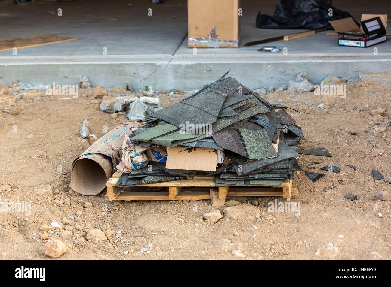Stack of construction refuse paper and roofing shingles on a pallet in ...