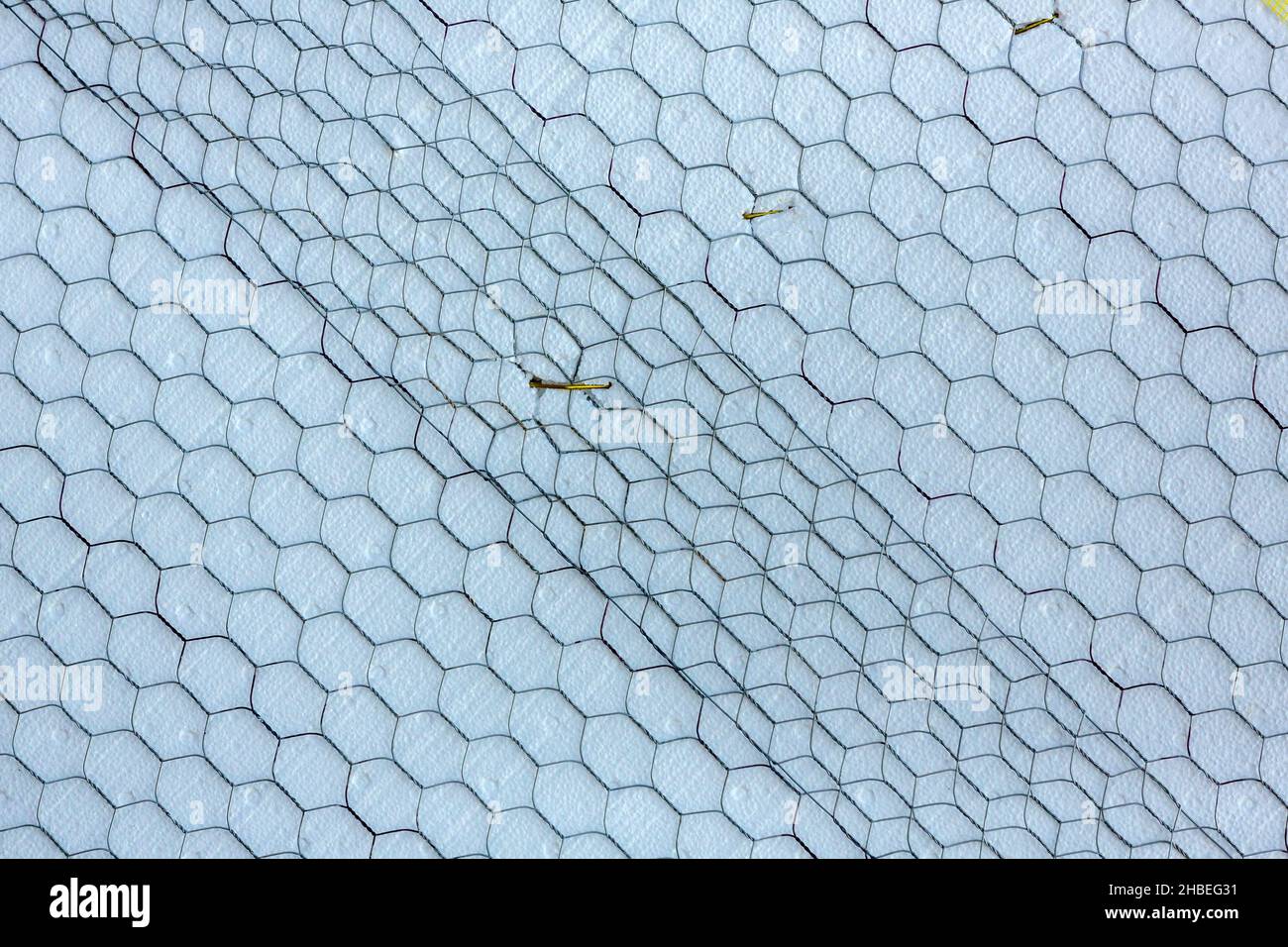 Overlapping panels of construction mesh over a white foam surface Stock ...