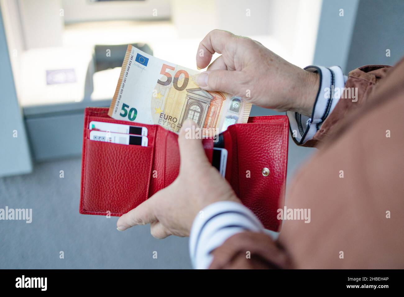 ATM machine and euros cash. Closeup of woman hand holding euro ...