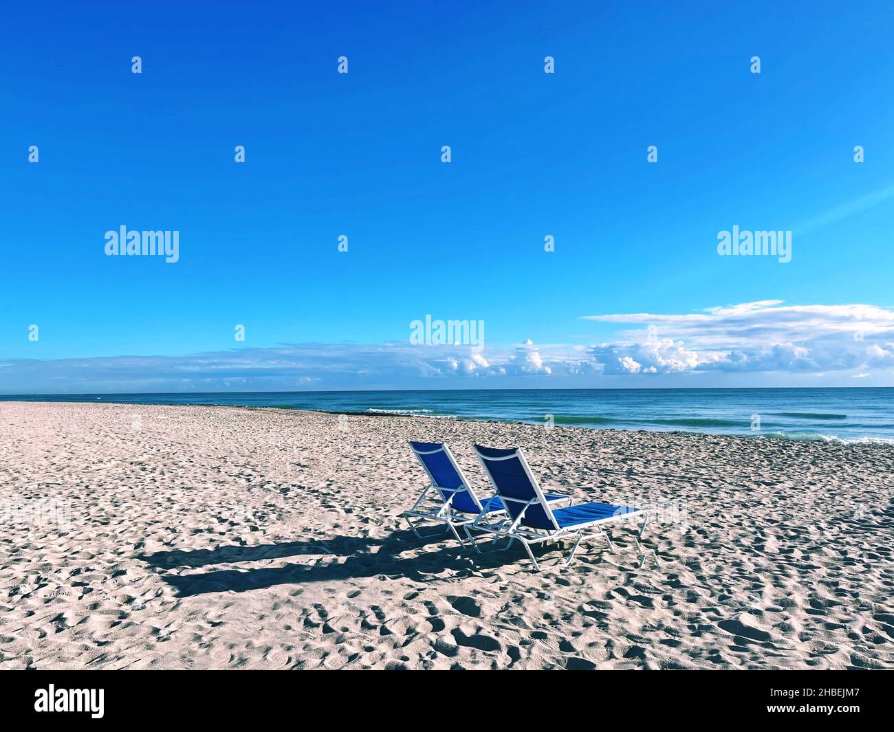 Two empty sun loungers on beach, Miami Beach, Miami, Florida, USA Stock ...