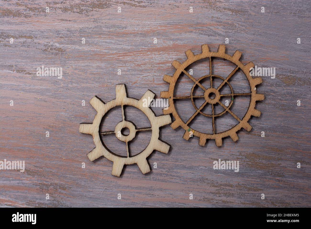 Two wooden gears on a textured background Stock Photo - Alamy