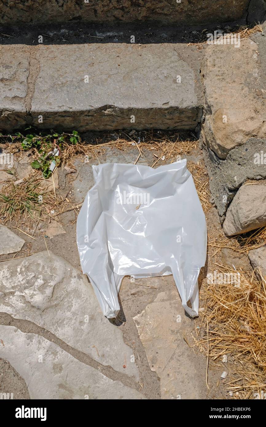 One plastic bag litter at old city street Stock Photo - Alamy