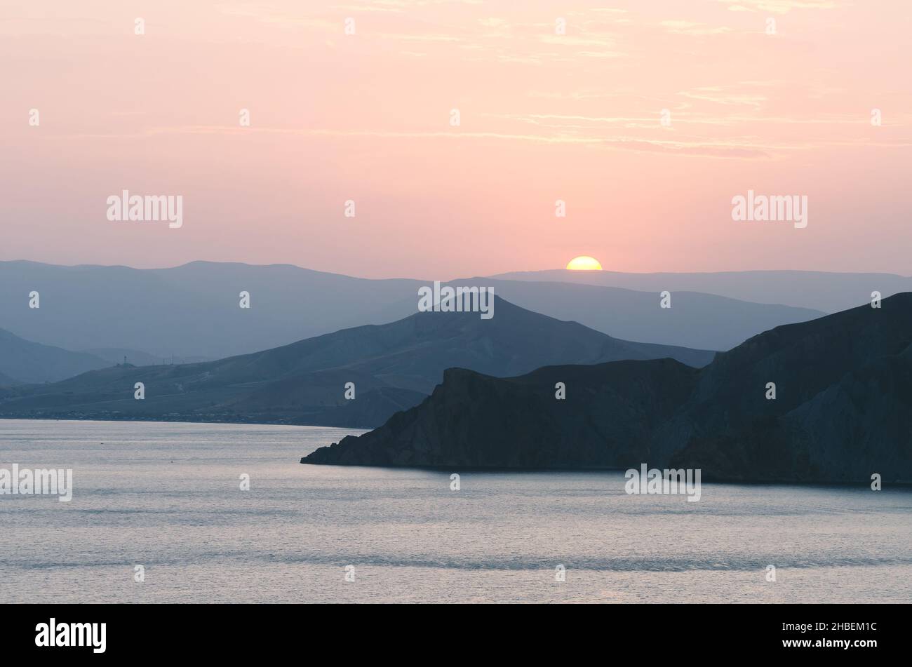 Summer sea landscape. View of the mountains and the setting sun. Crimea ...