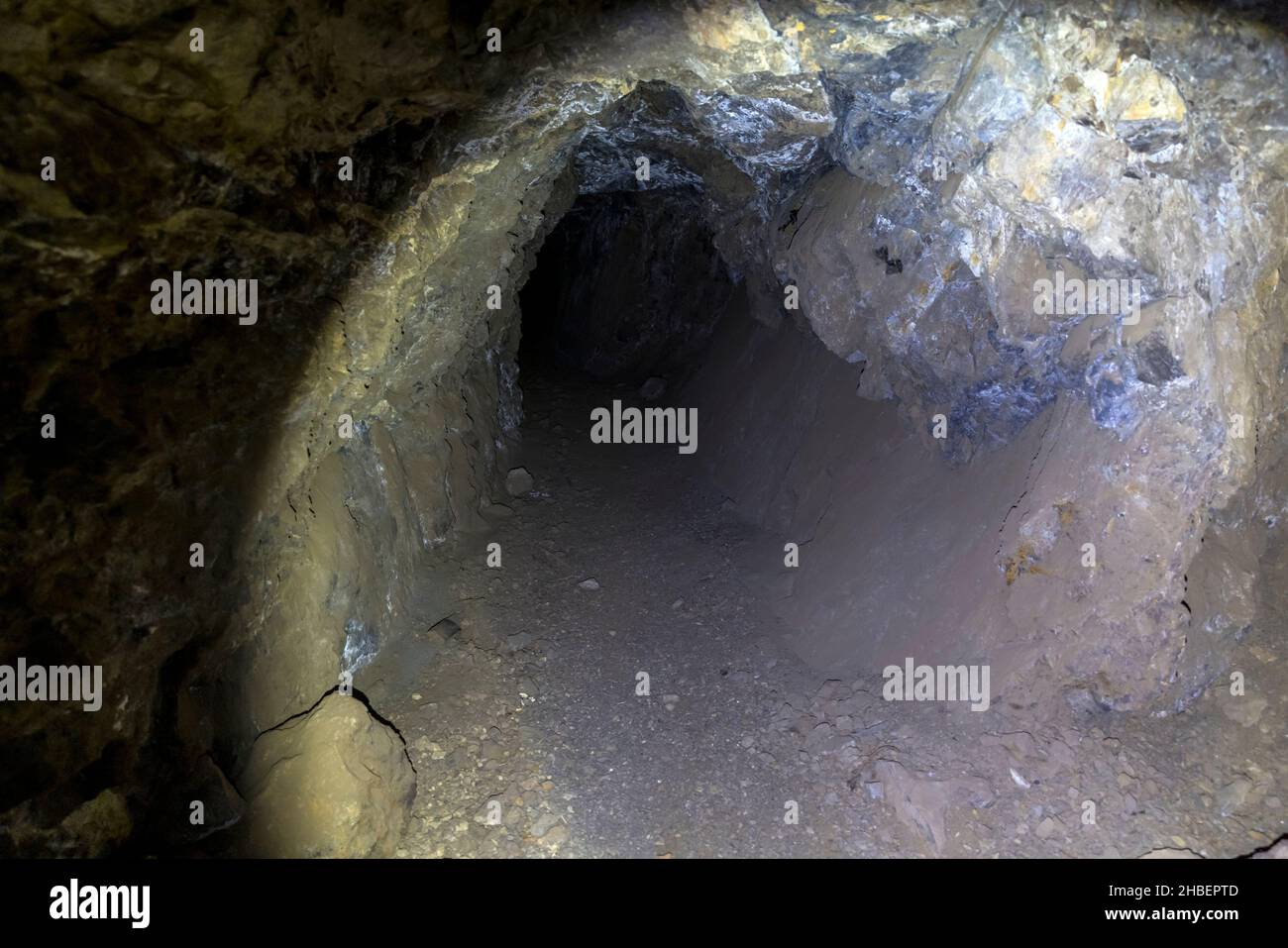 Flashlight beam illuminates the shaft of an underground tunnel Stock ...