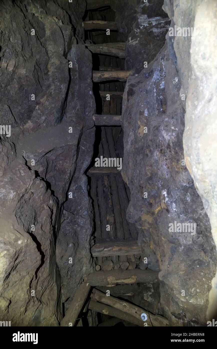 Timbers brace a long open area with wooden platform inside a mining ...