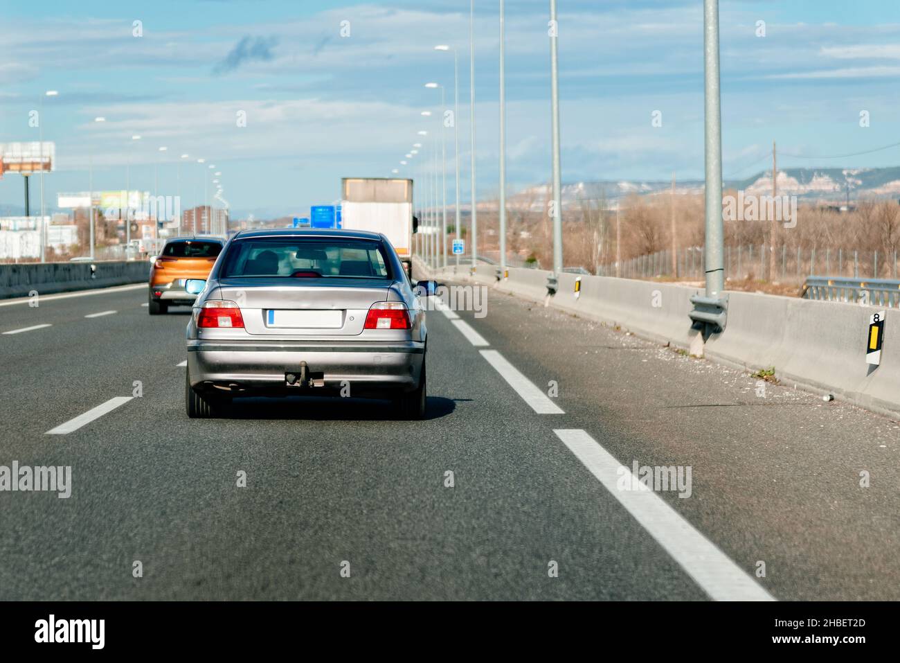 Vehicles driving on the highway in heavy traffic. Rear view with copy ...
