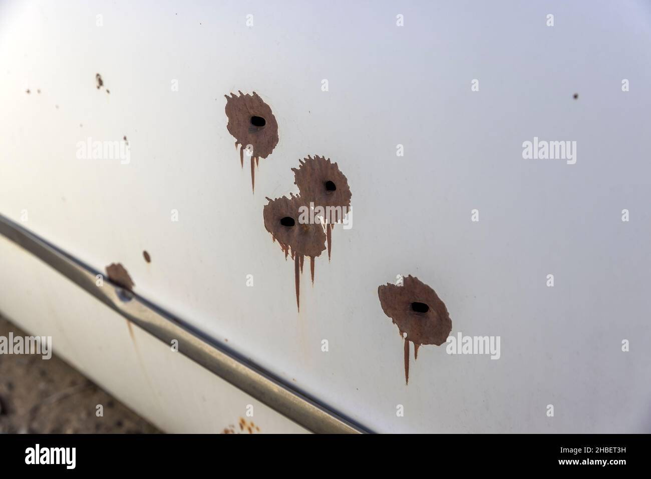Rusty bullet holes in the side of a vintage automobile door Stock Photo ...