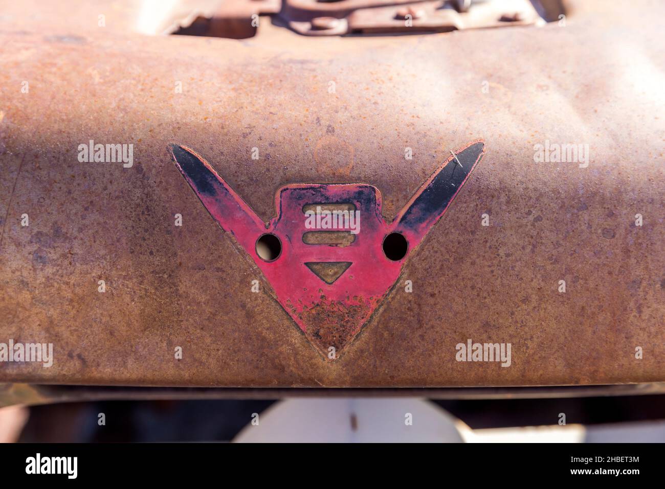 Paint outline left behind on a rusty hood from a car emblem that fell ...