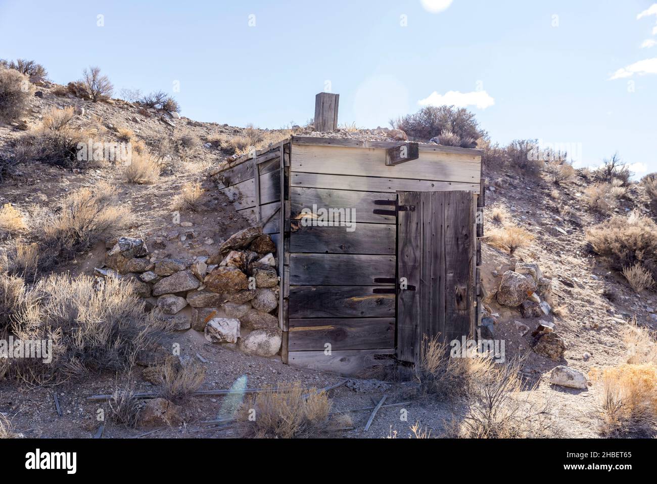 Old mining cabin with the door closed set into the side of a hill in ...