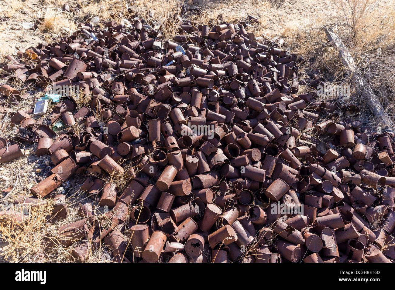 Trash pile of rusty old cans from a mining claim in the desert Stock ...