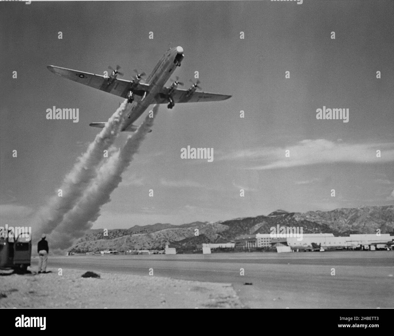 US military 4 engine prop plane taking off Stock Photo - Alamy