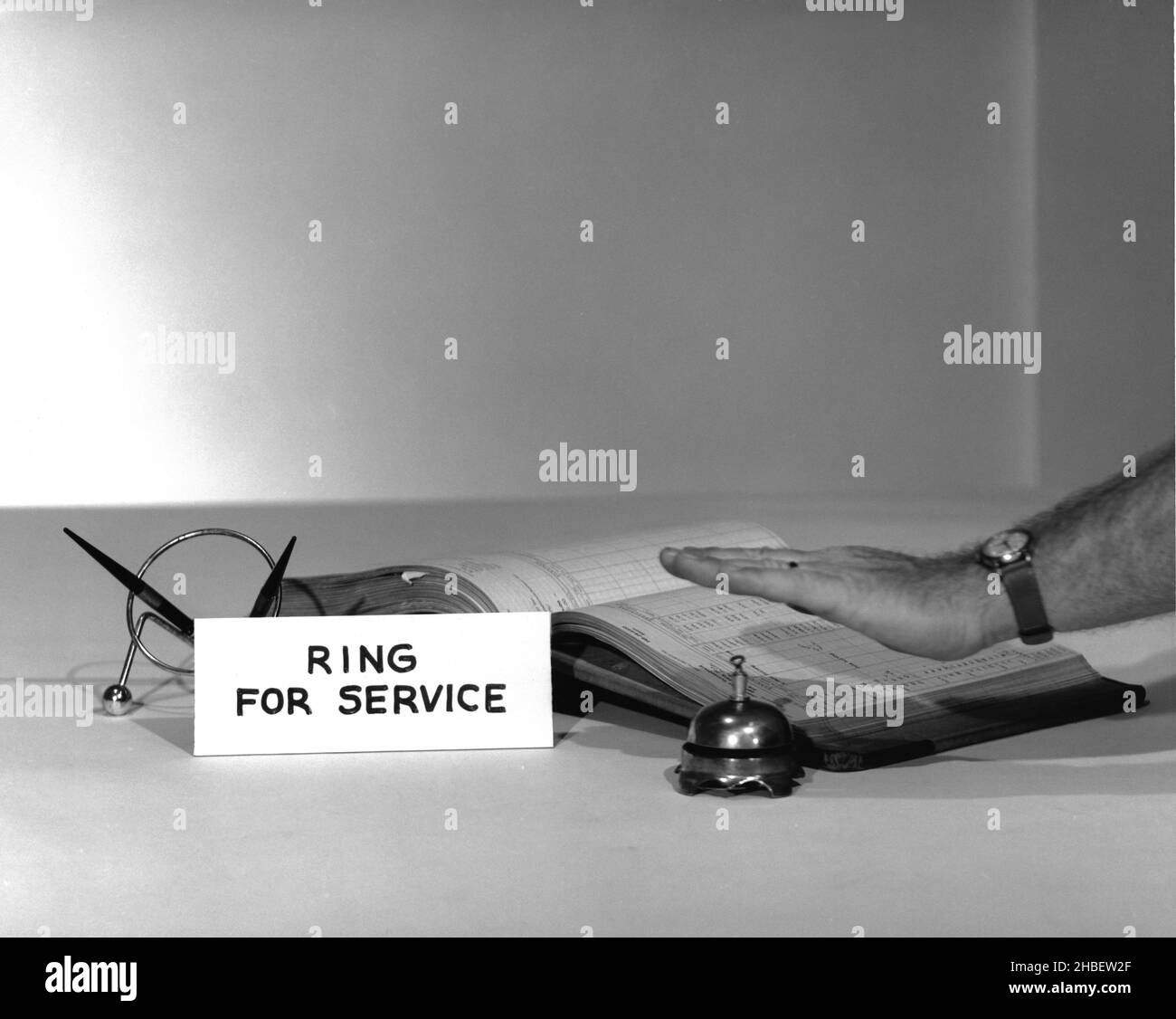 Symbolic shot of hand hitting bell to Ring for Service Stock Photo - Alamy