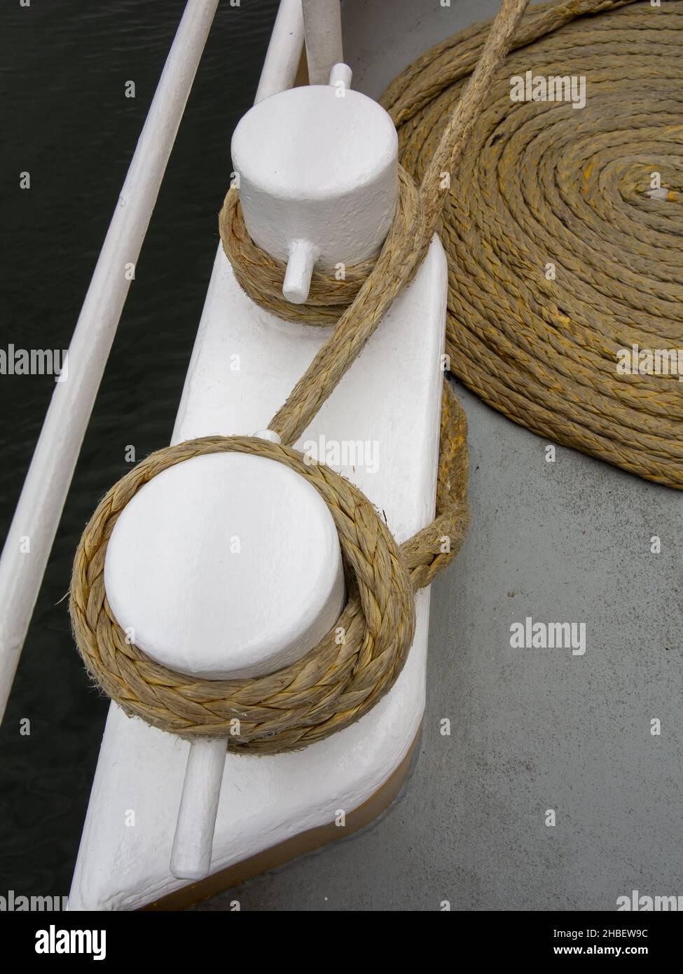 A thick rope wrapped around a strong post on the deck of a ship Stock ...