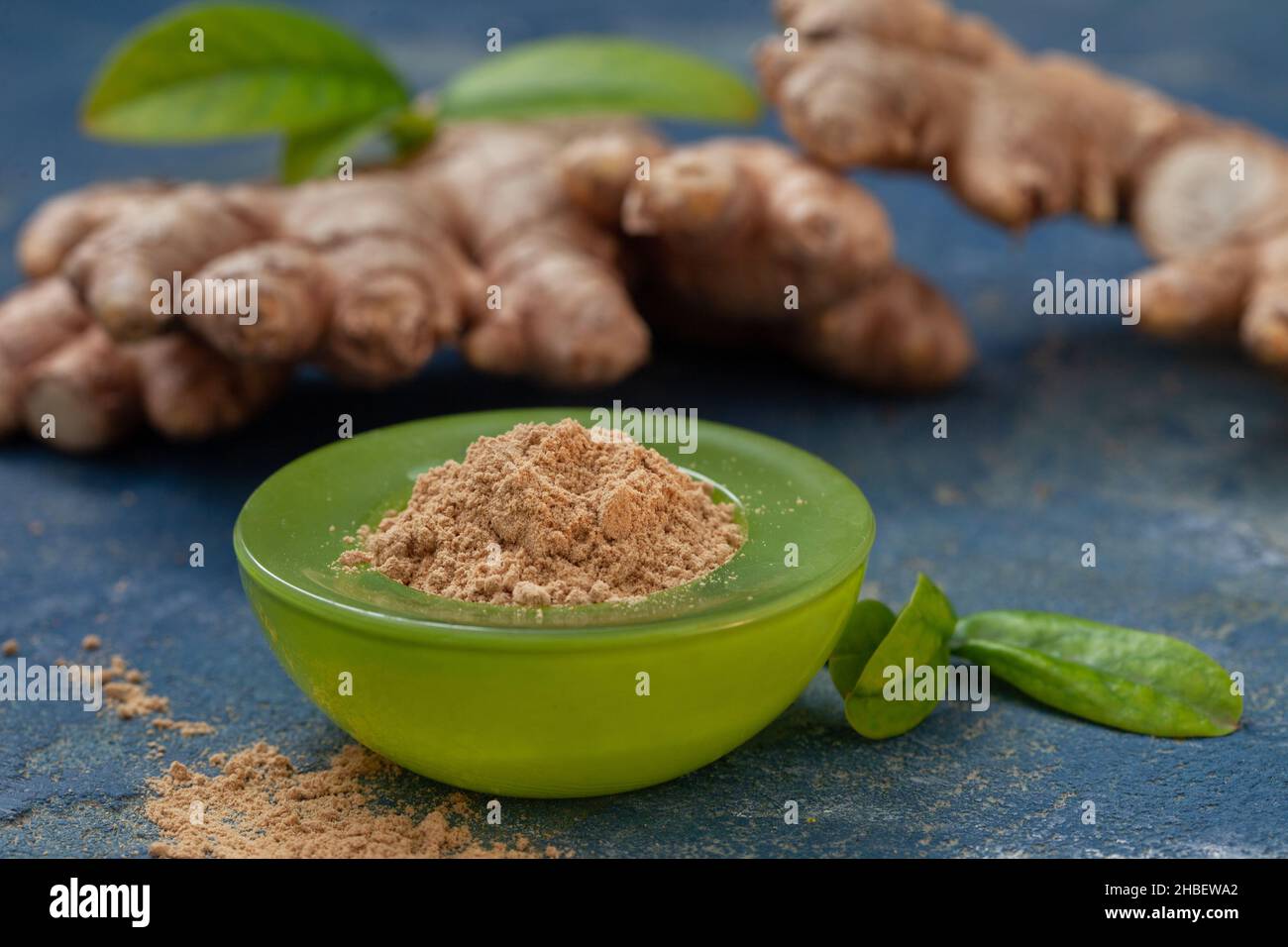 Fresh ginger root and ginger powder spice in the bowl. Healthy ...