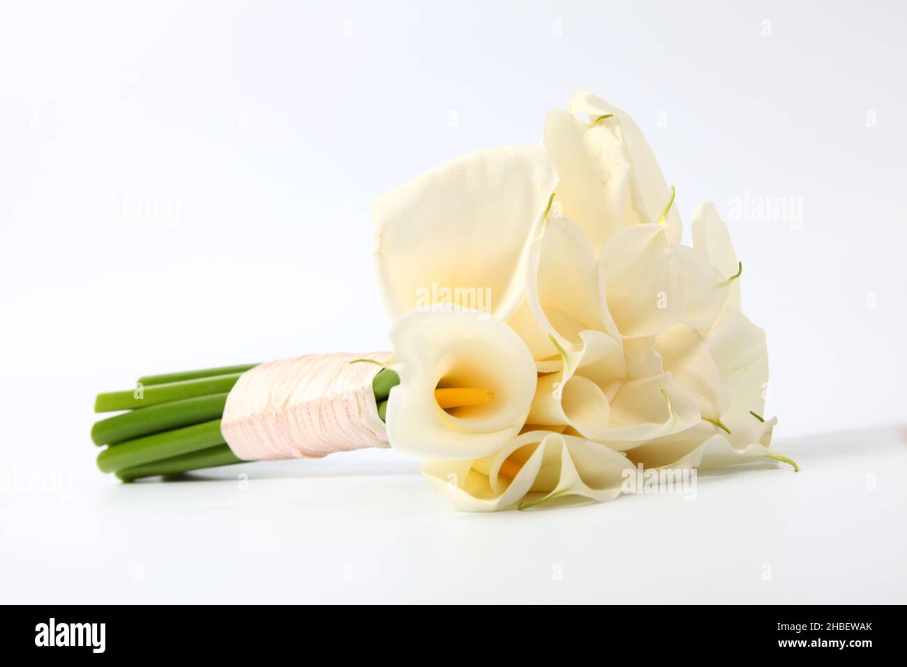 Classic bridal bouquet of large calla lilies on a light background ...