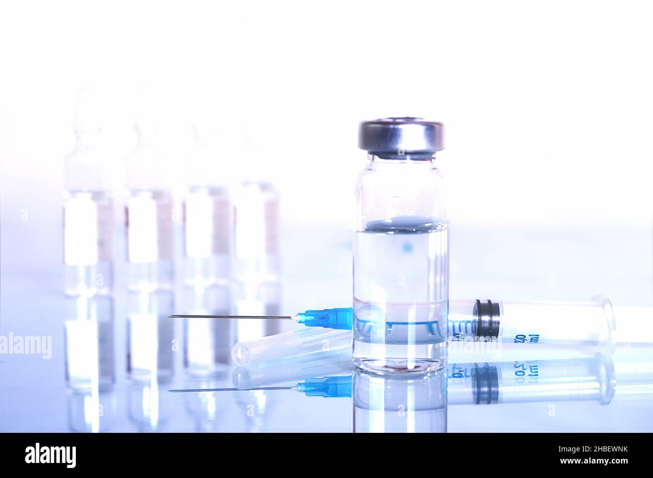syringe and diferent kind of ampoules and vials close-up on white ...