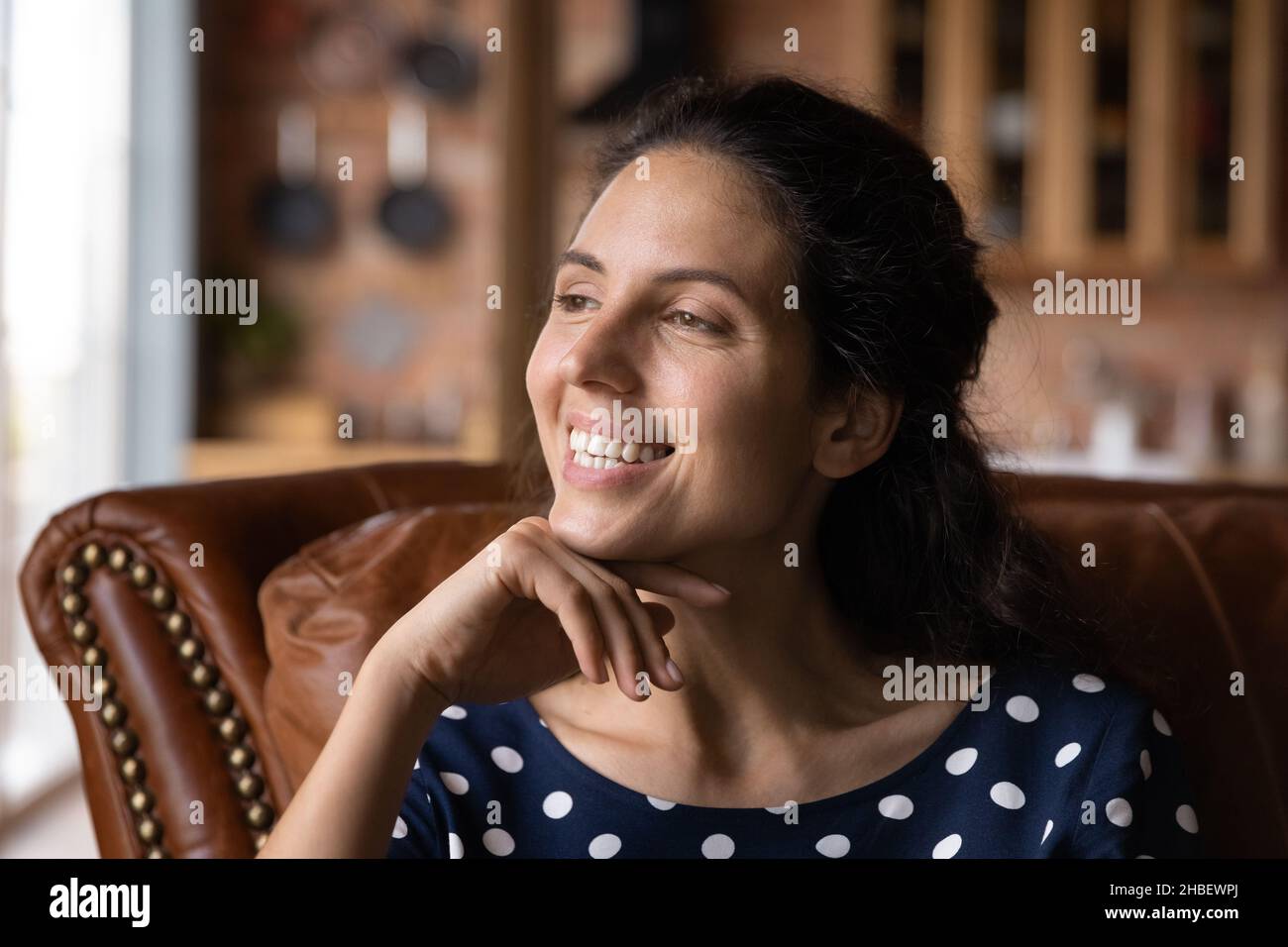 Happy dreamy millennial woman looking in distance Stock Photo - Alamy