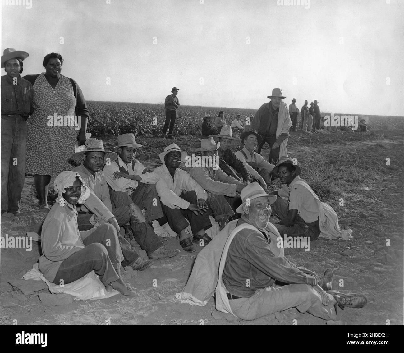 Group of men and woman migrant workers take a break. Circa 1942 Stock ...