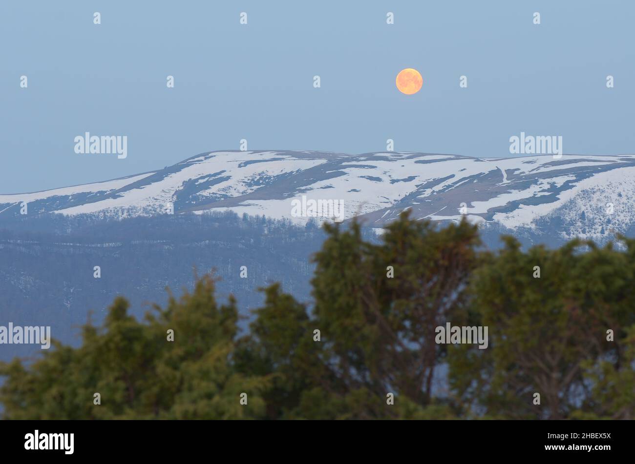 Morning landscape with a full moon over the mountain ridge Stock Photo ...