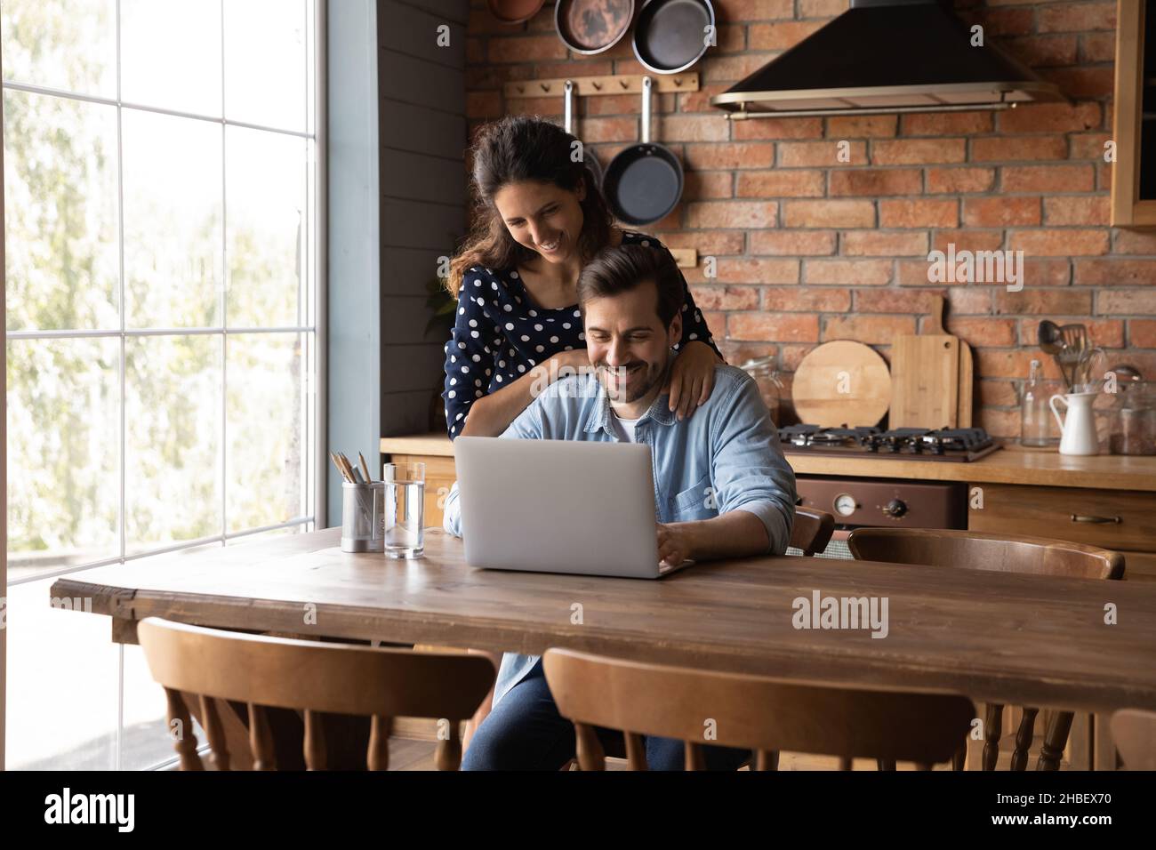 Happy millennial couple using computer together at home Stock Photo - Alamy