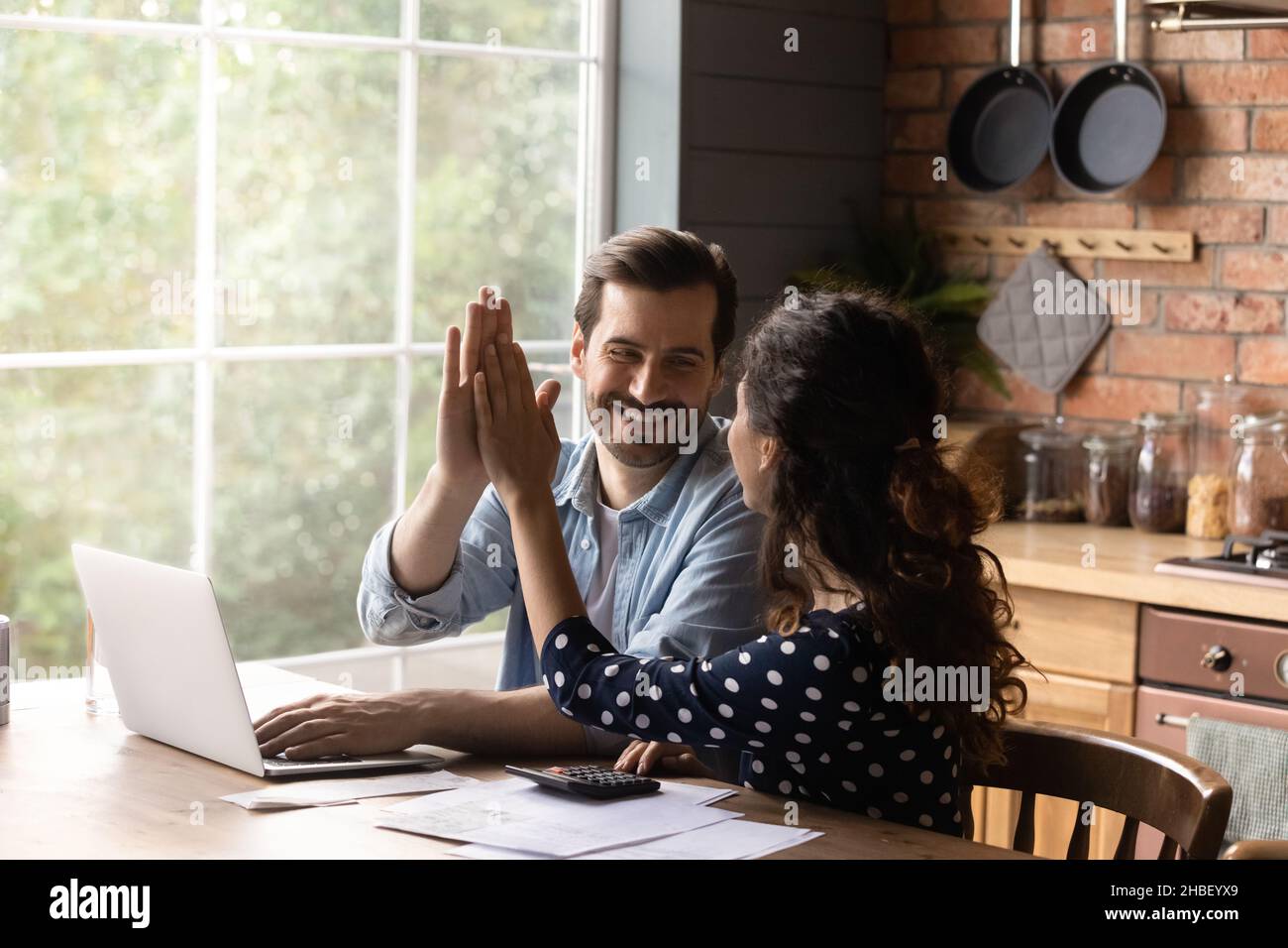 Happy young family couple celebrating successful investment Stock Photo ...