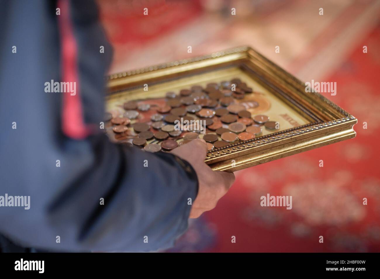 The believer man collects donations in the church. Benefactors puts ...