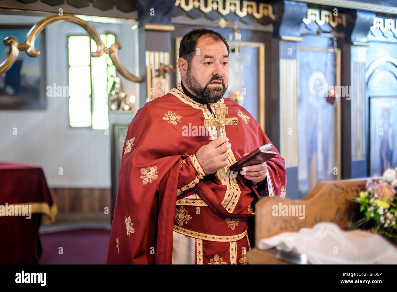 Religious priest holds a holy Christian cross in his hand during a ...