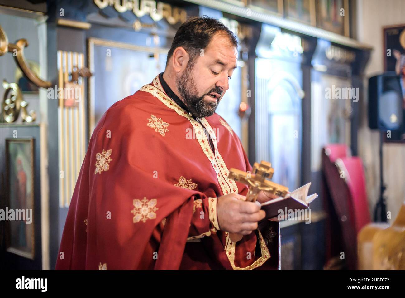 Religious priest holds a holy Christian cross in his hand during a ...