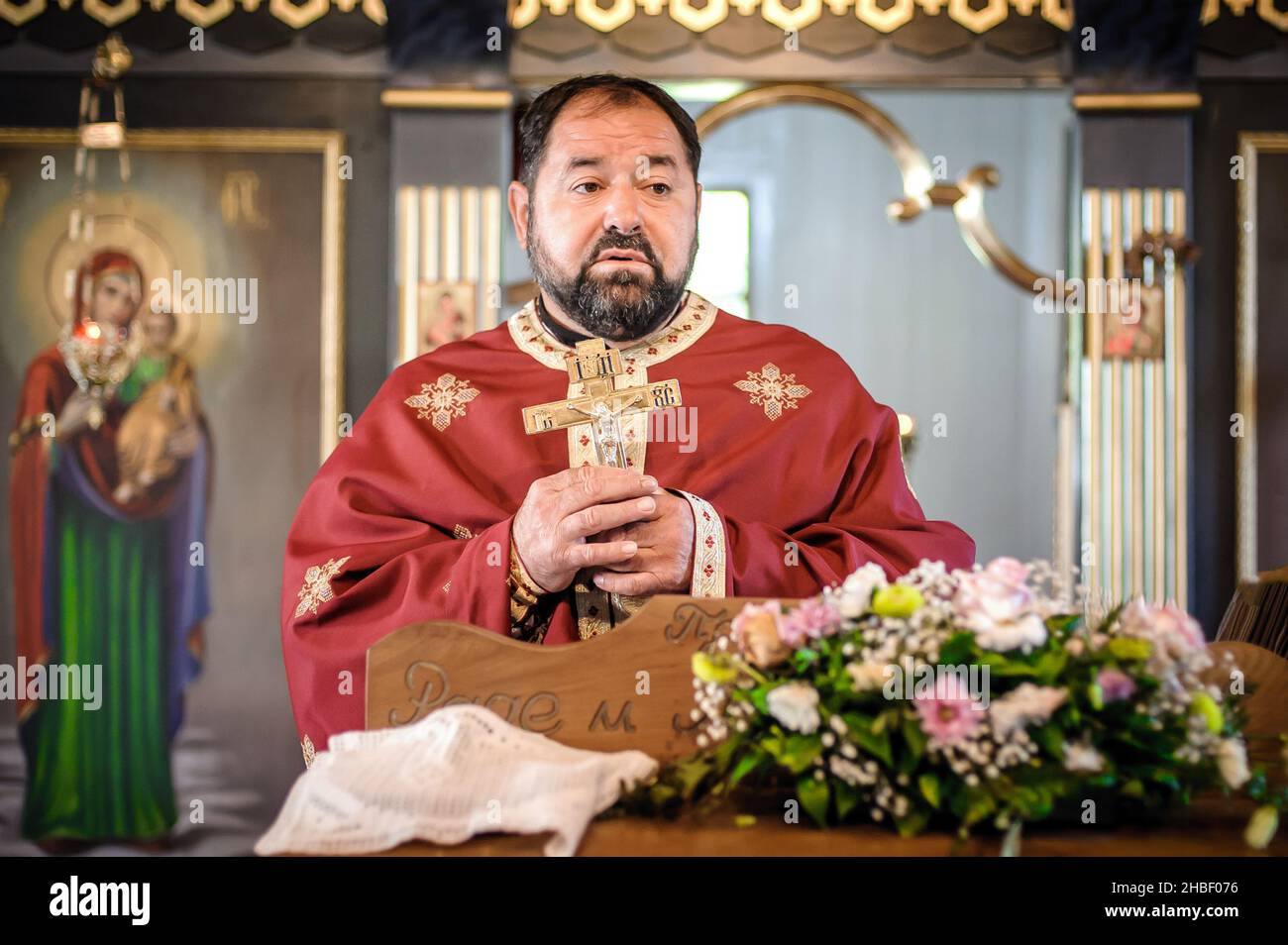 Religious priest holds a holy Christian cross in his hand during a ...