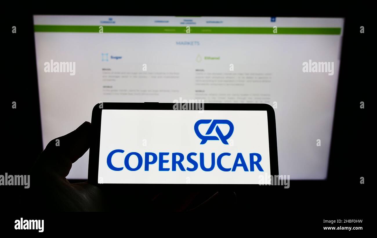 Person holding cellphone with logo of Brazilian sugar and ethanol ...